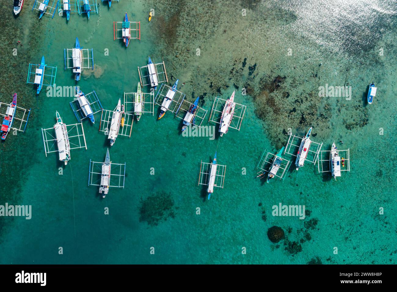 Top drone view of a traditional philippine boats on the surface of the ...