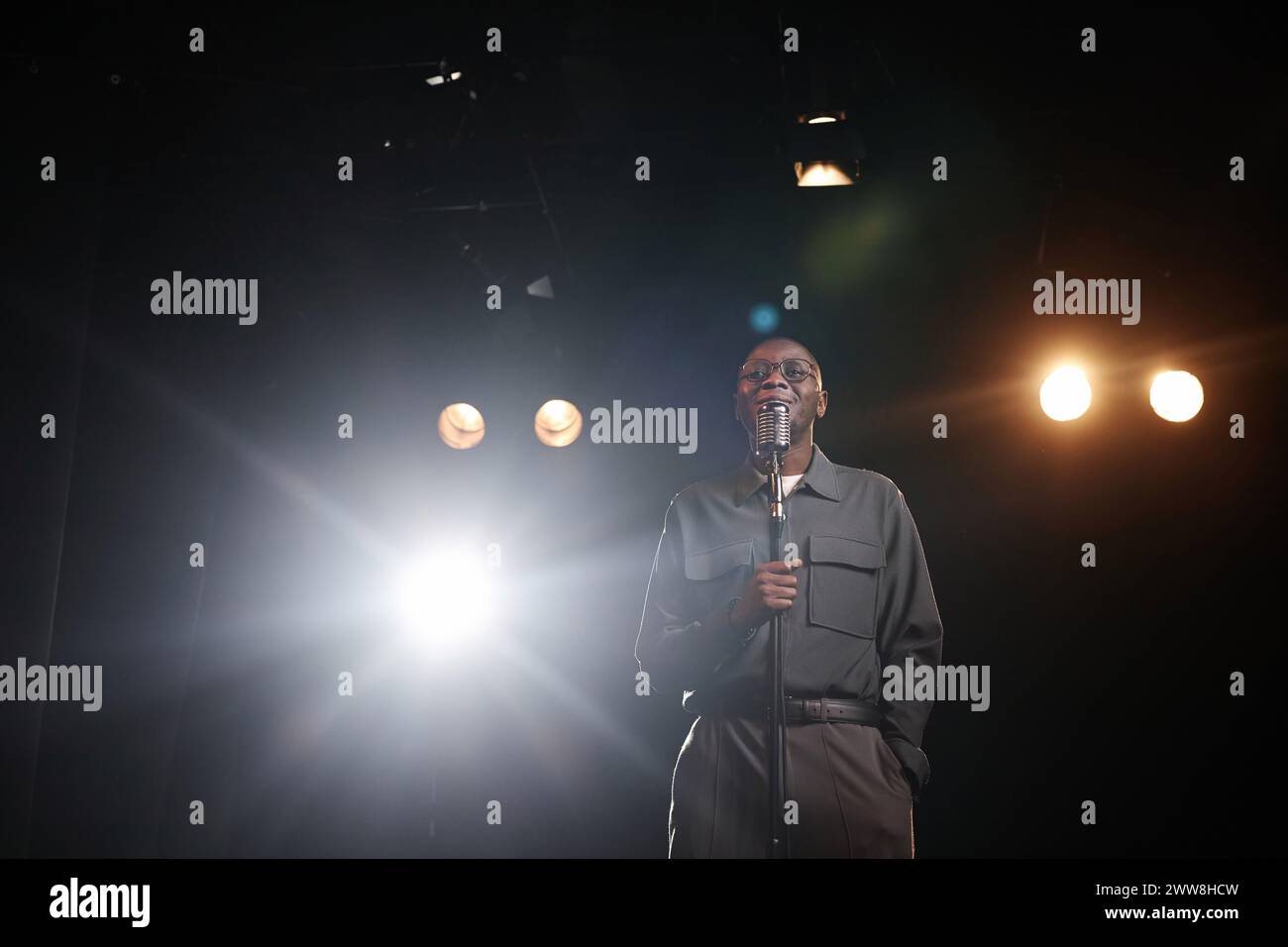 Wide angle shot of African American man speaking to microphone standing ...