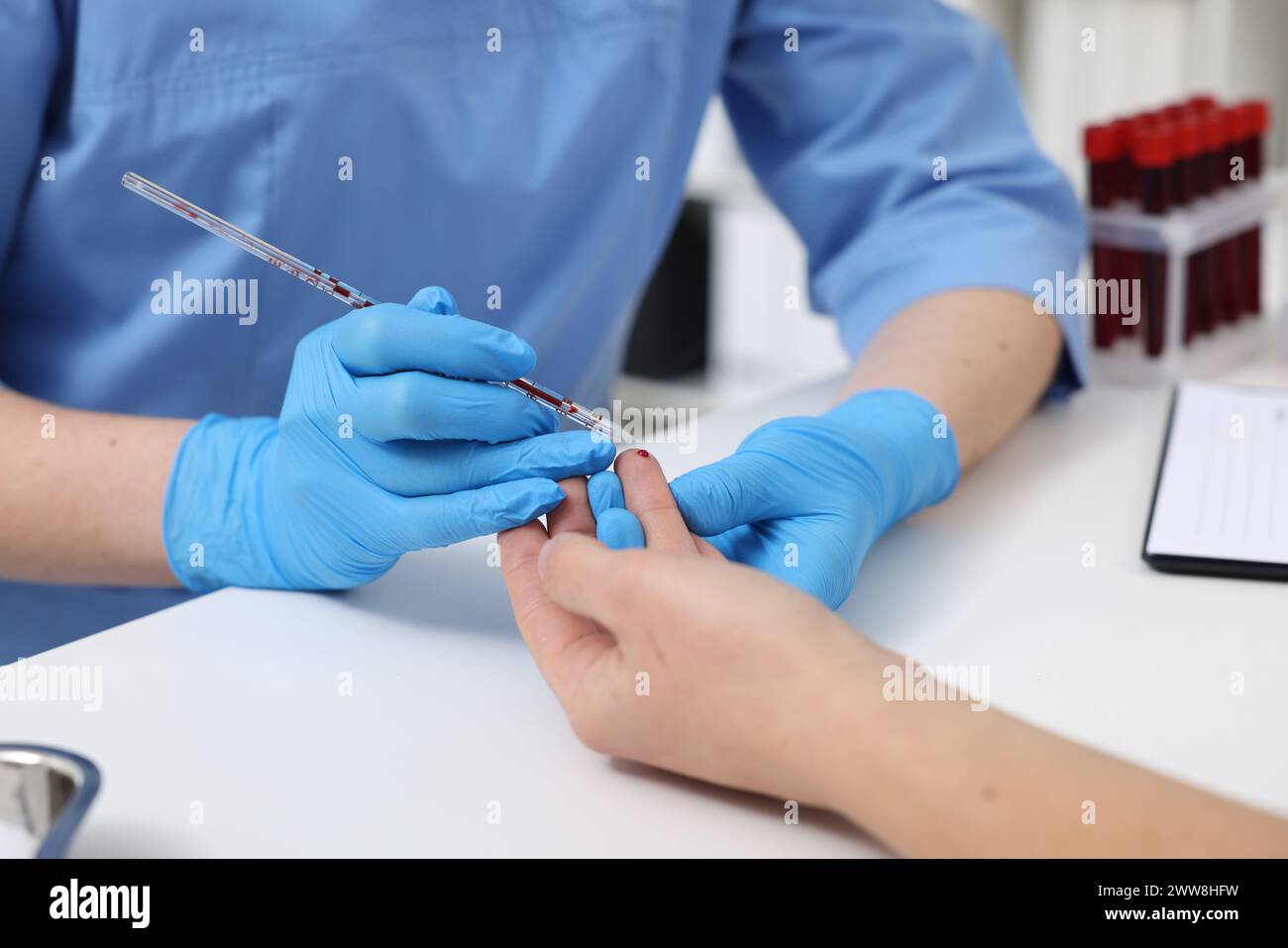 Laboratory testing. Doctor taking blood sample from patient at white ...