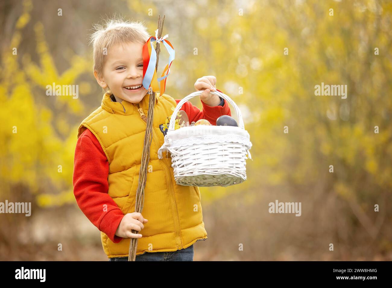 Cute preschool child, boy, holding handmade braided whip made from ...