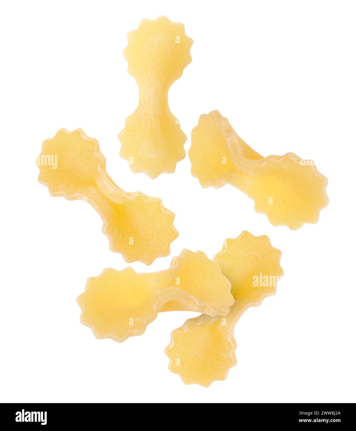 Raw farfalline pasta falling on white background Stock Photo - Alamy