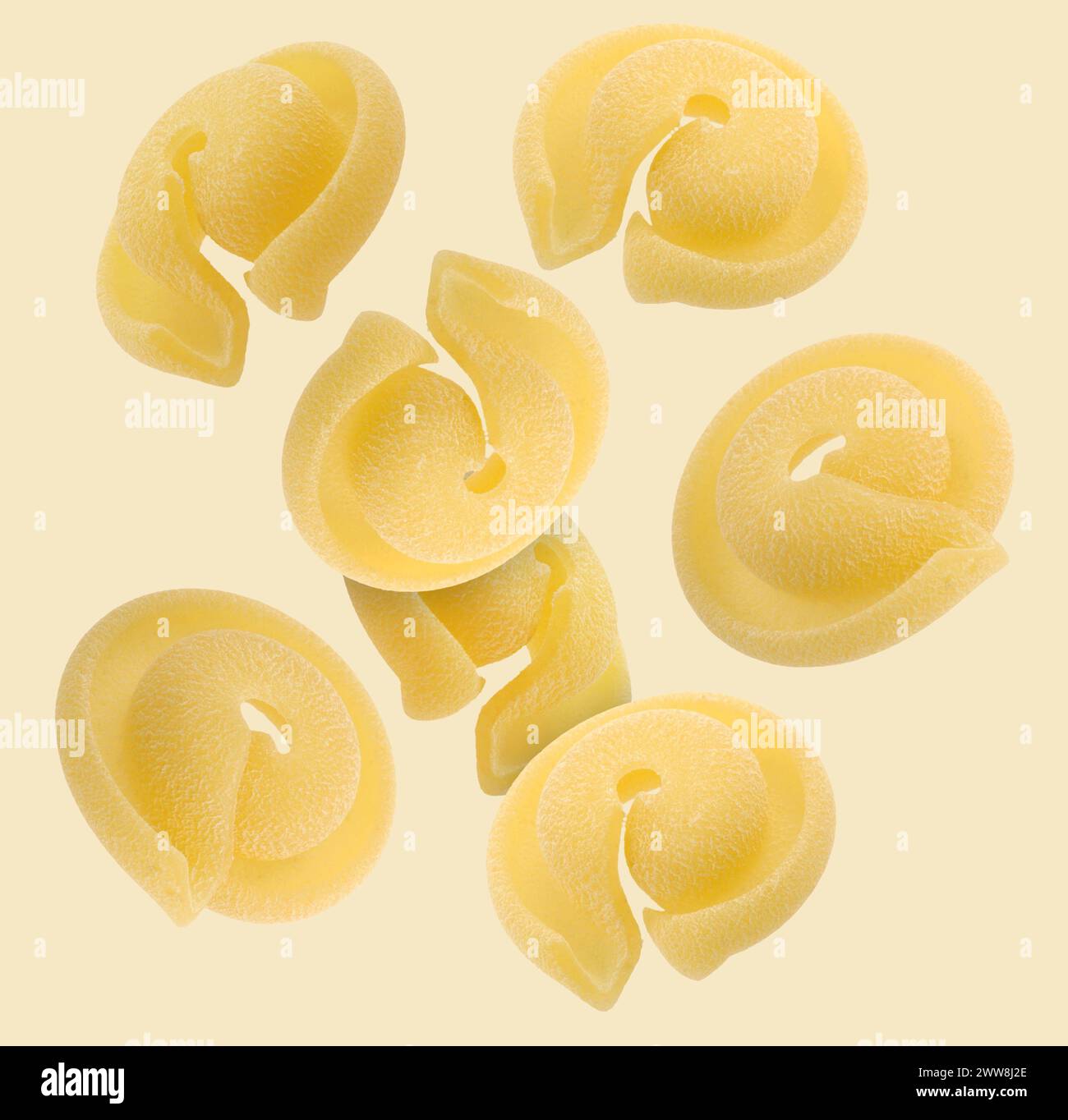 Raw dischi volanti pasta flying on beige background Stock Photo - Alamy