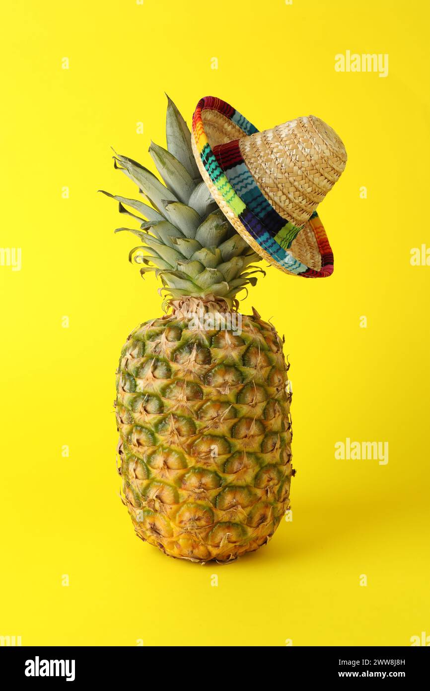 Pineapple with Mexican sombrero hat on yellow background Stock Photo ...