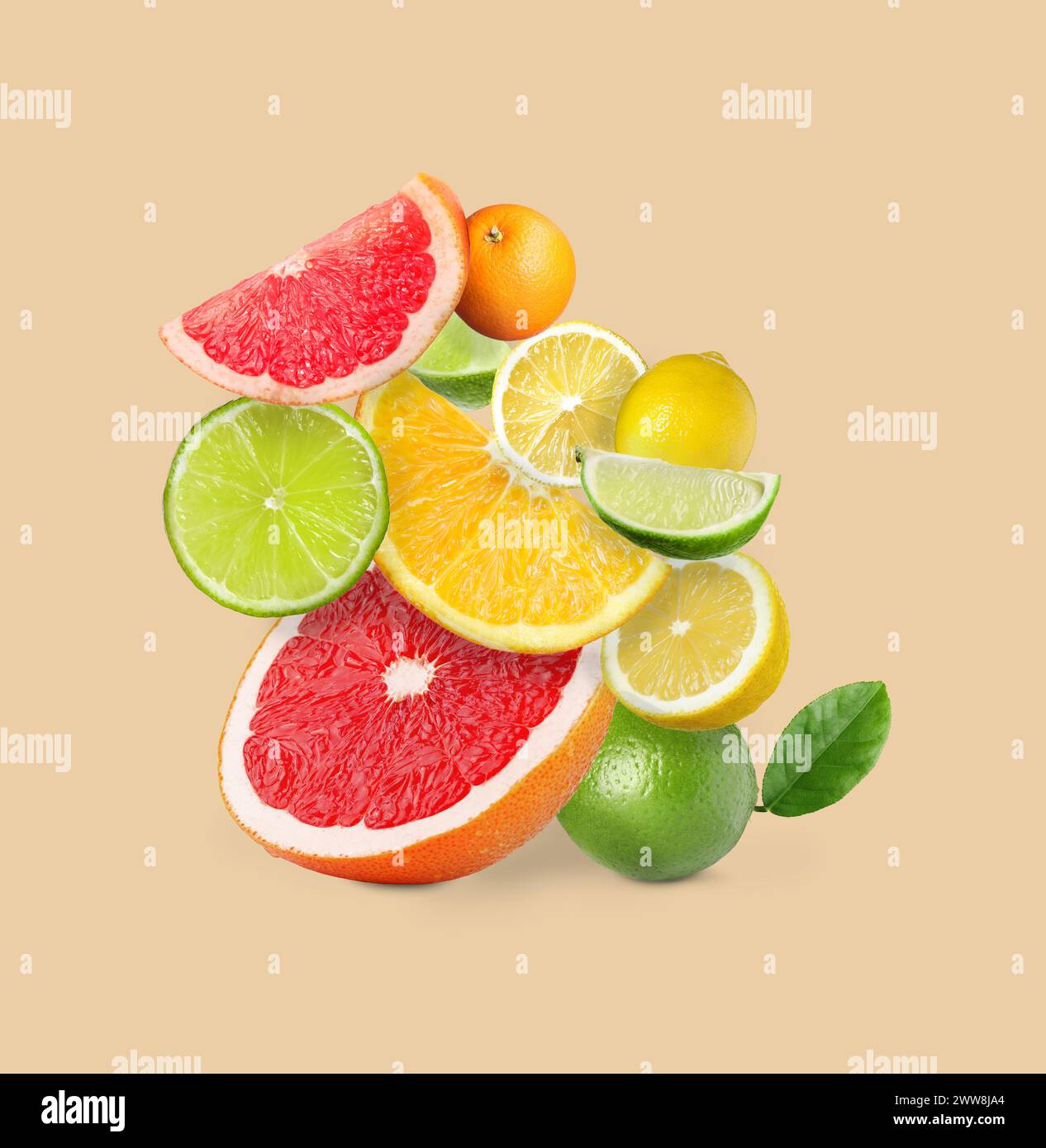 Stack of different citrus fruits on beige background Stock Photo - Alamy