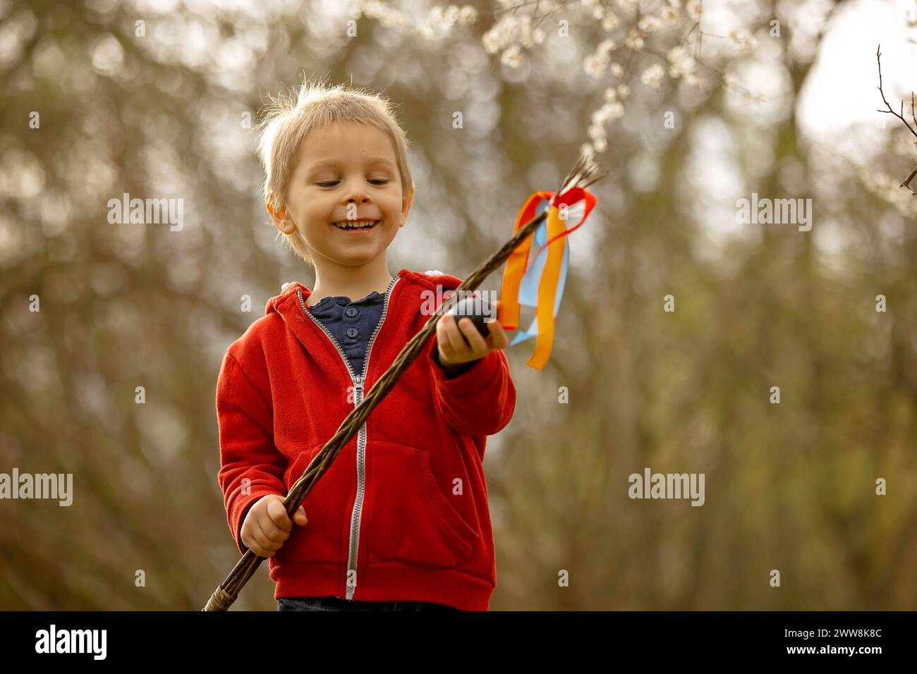 Cute preschool child, boy, holding handmade braided whip made from ...