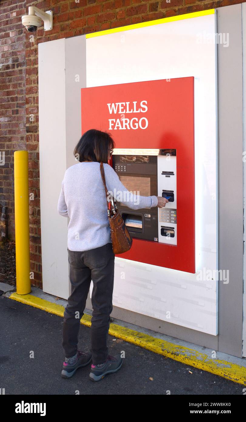 A customer uses an ATM machine at a Wells Fargo Bank in Asheville ...