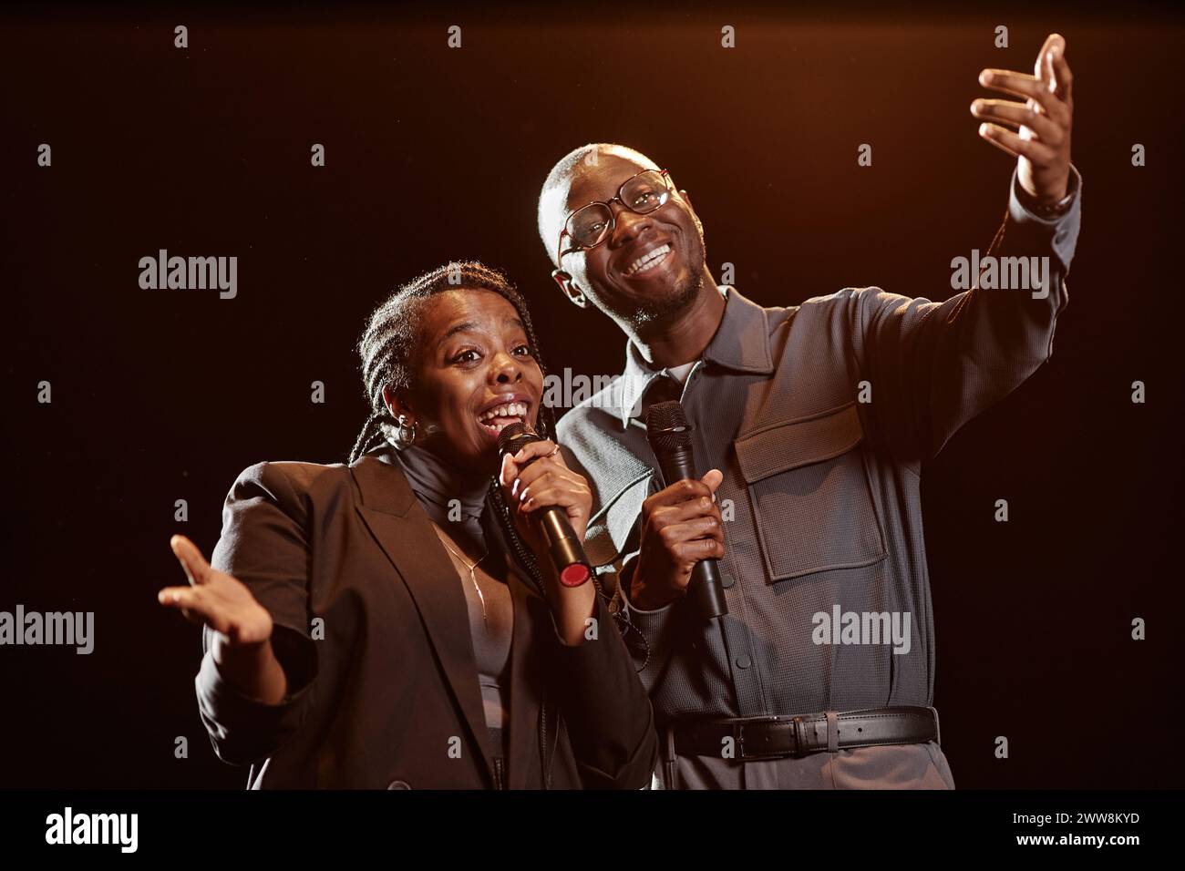 Waist up portrait of two African American performers on stage speaking ...