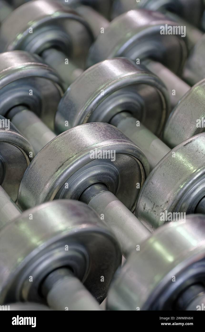Steel conveyor rollers, close-up shot, abstract industrial background ...