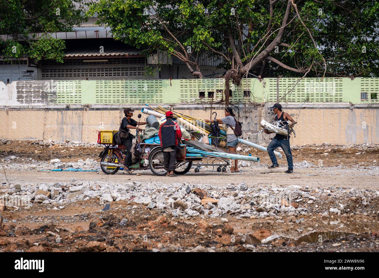 A team of waste pickers is seen adding collected garbage to their ...