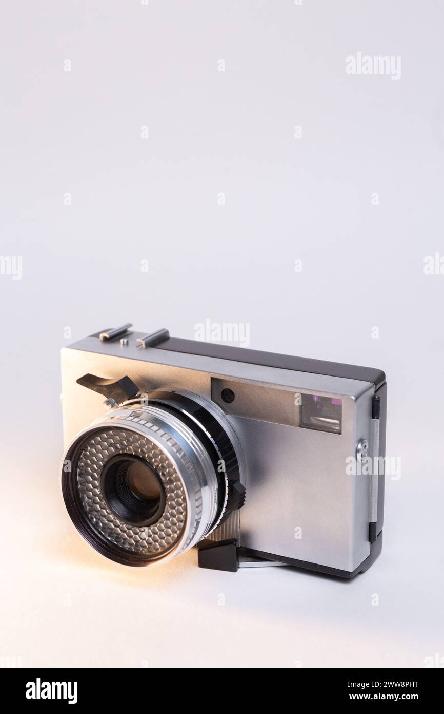 Vintage film camera with a sleek silver body and a classic black manual ...