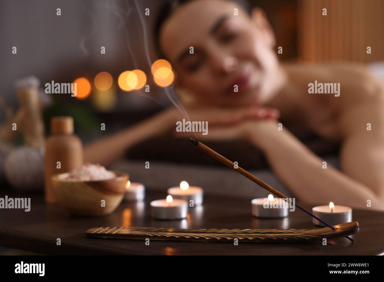Spa therapy. Beautiful young woman lying on massage table in salon ...