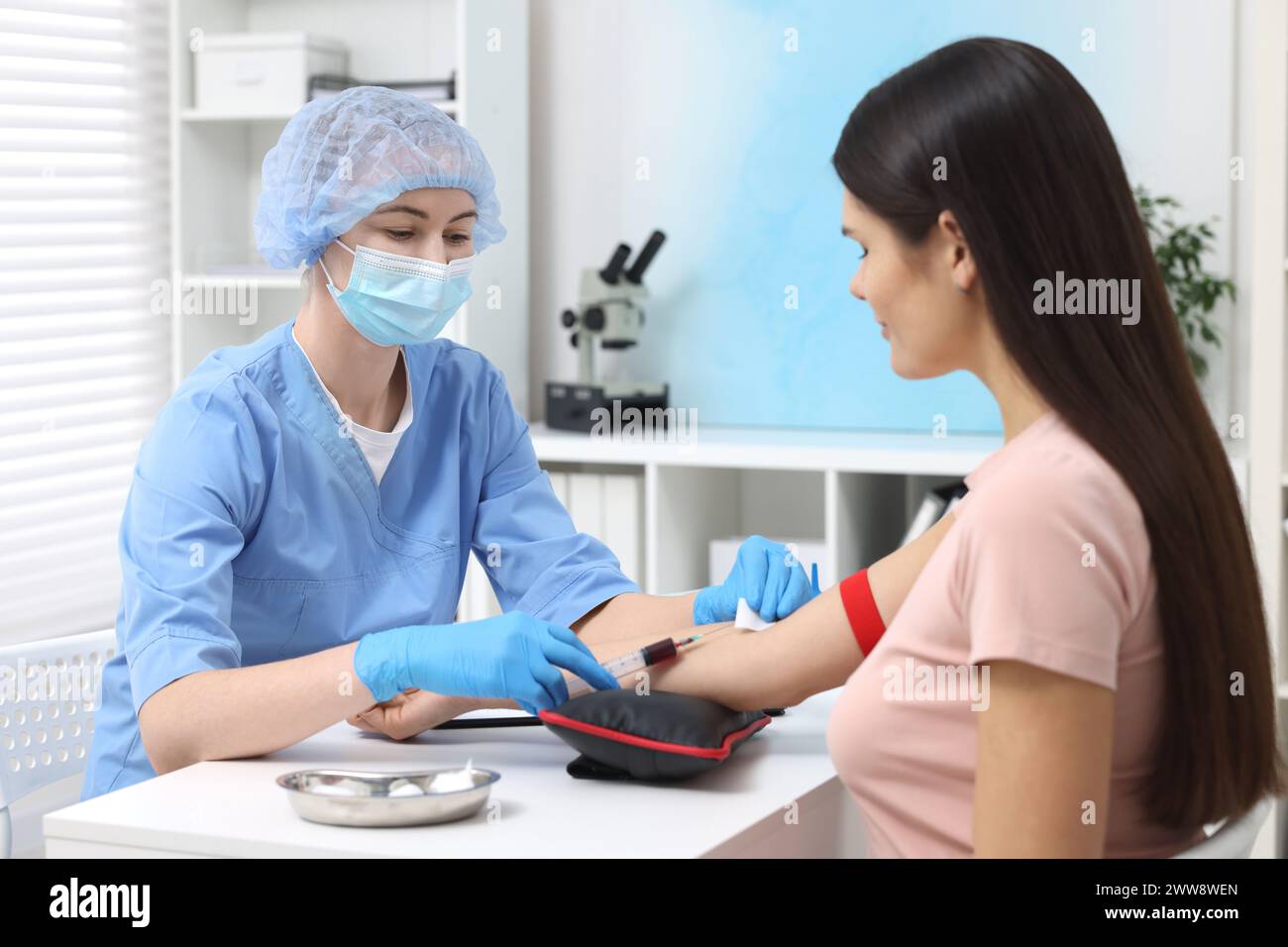 Laboratory testing. Doctor taking blood sample from patient at white ...