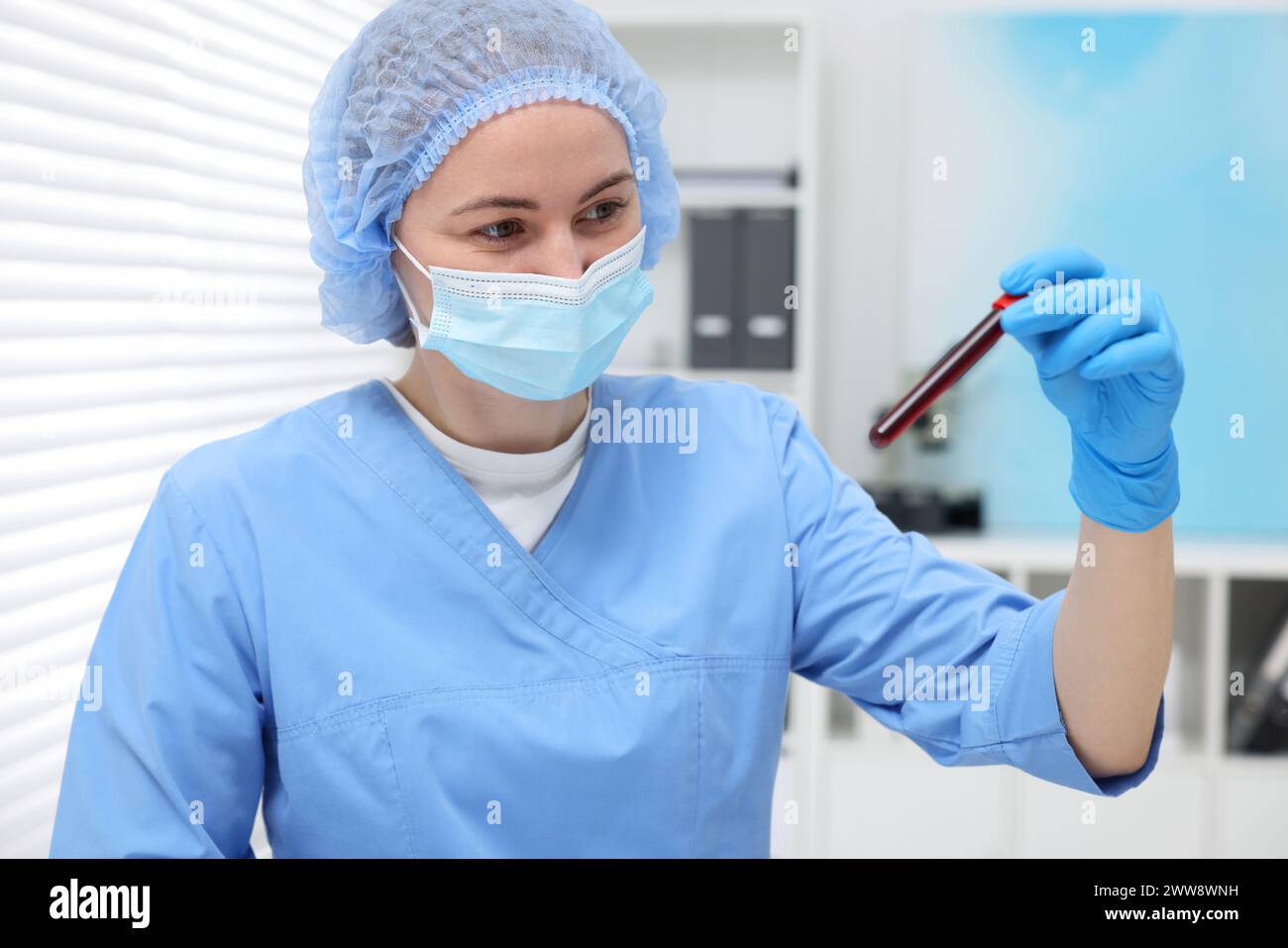 Laboratory testing. Doctor with blood sample in tube at hospital Stock ...