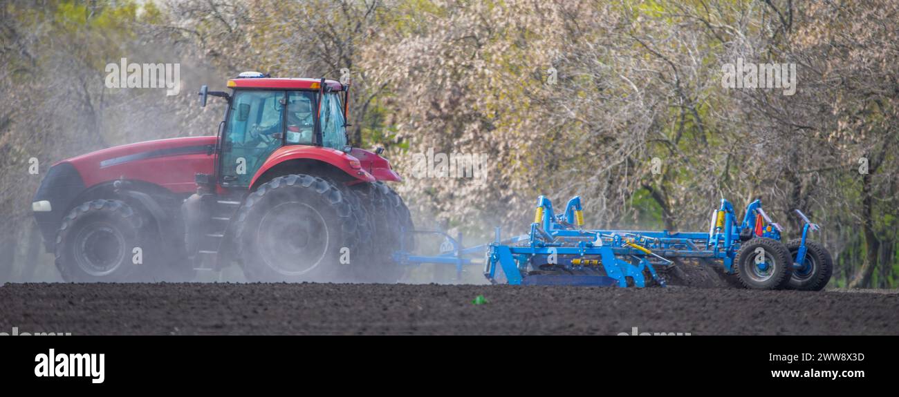 Precision Farming: Tractor Cultivating for Growth Stock Photo - Alamy
