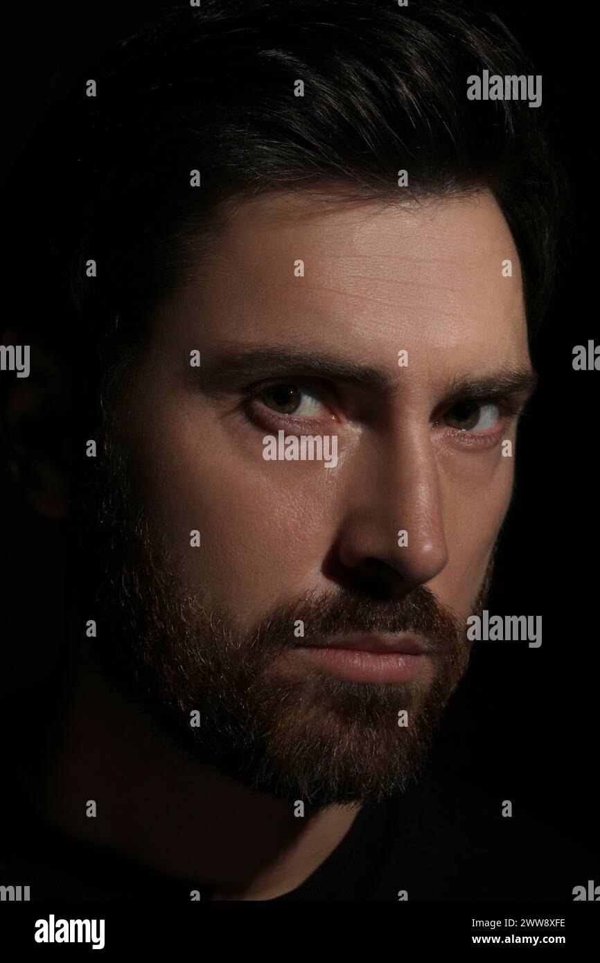 Evil eye. Man with scary eyes in darkness, closeup Stock Photo - Alamy
