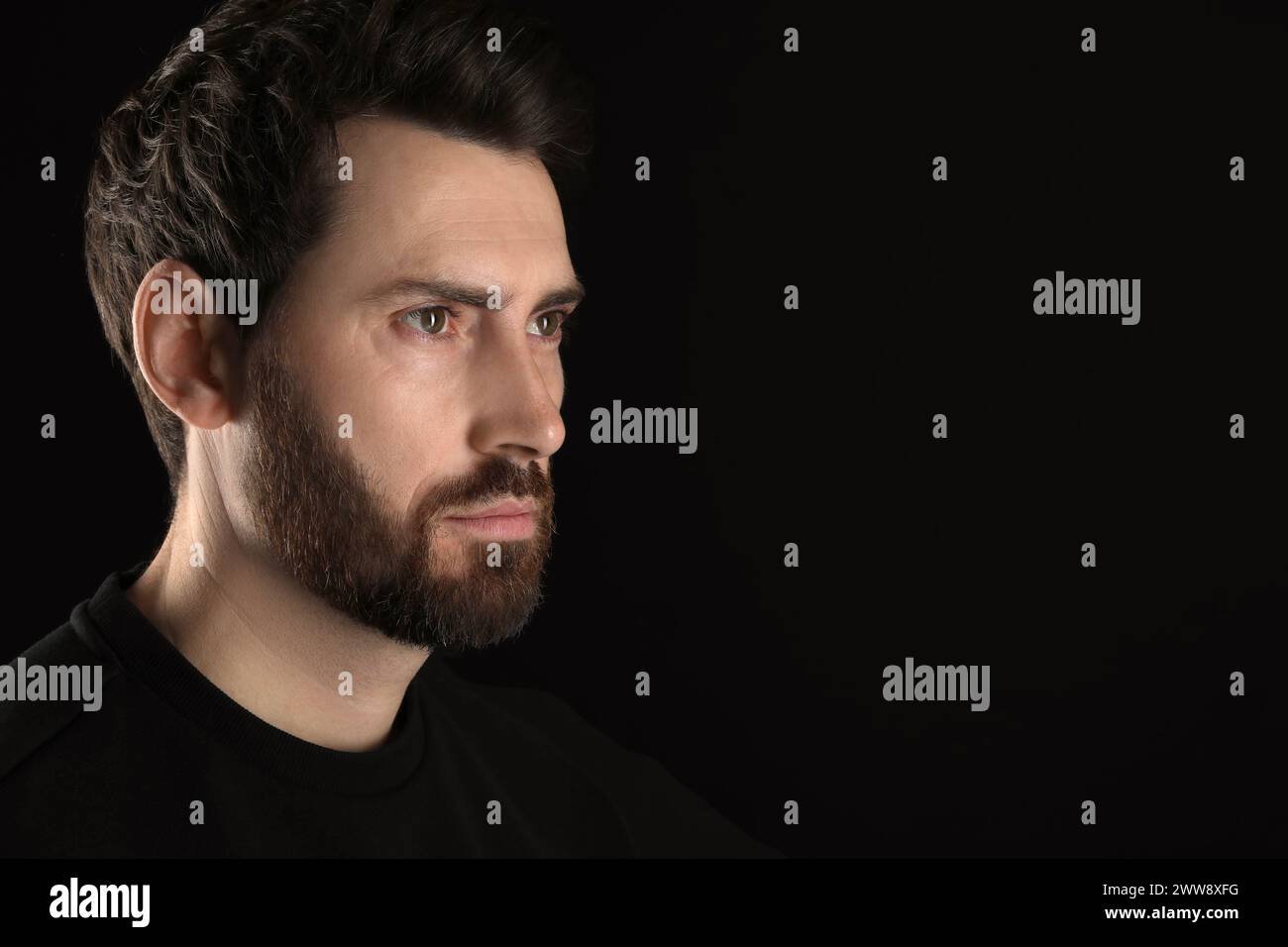 Evil eye. Man with scary eyes on black background, closeup and space ...