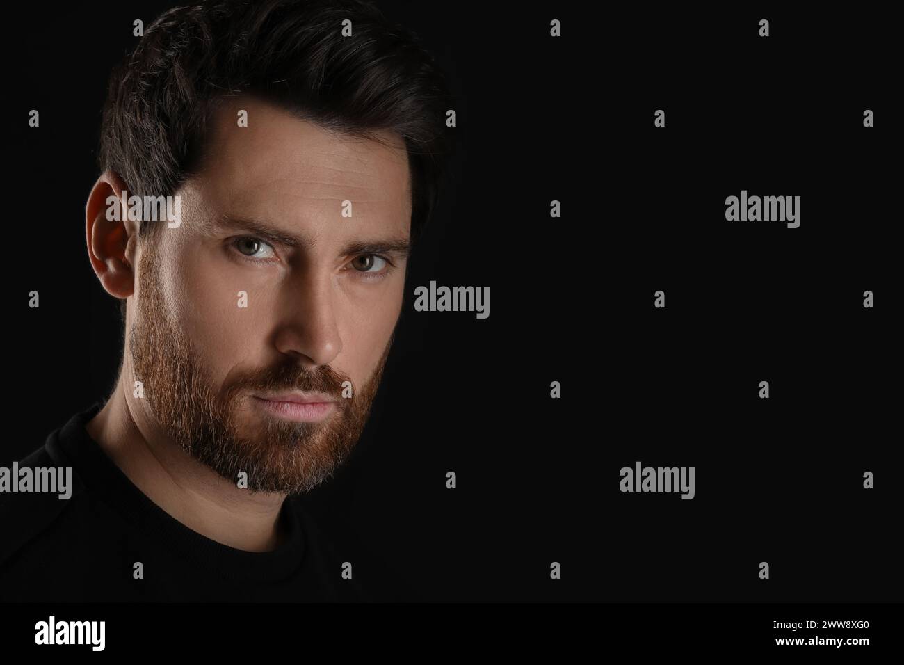 Evil eye. Man with scary eyes on black background, closeup and space ...