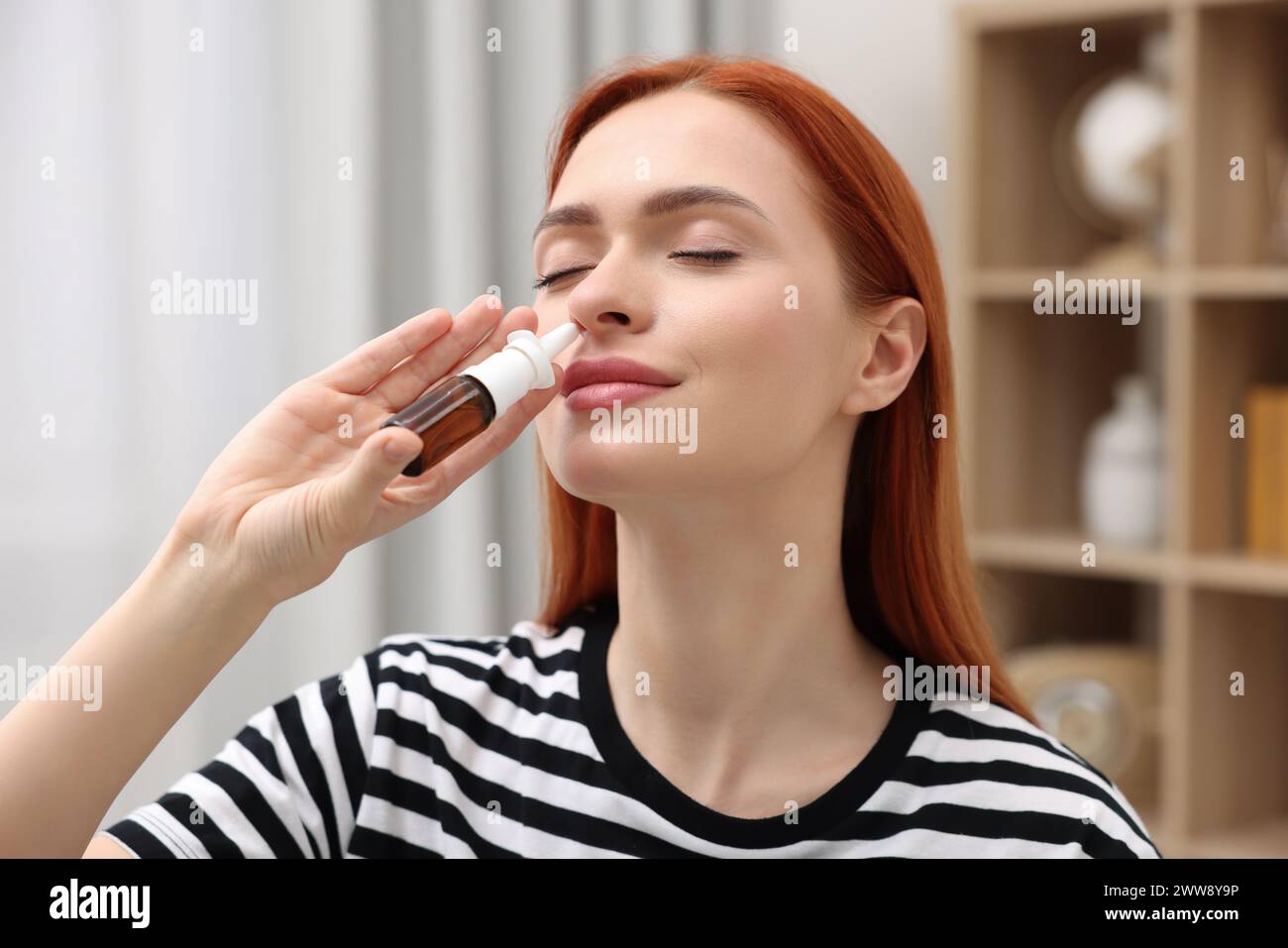 Medical drops. Woman using nasal spray at home Stock Photo - Alamy