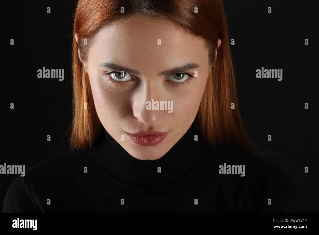Evil eye. Young woman with scary eyes on black background Stock Photo ...