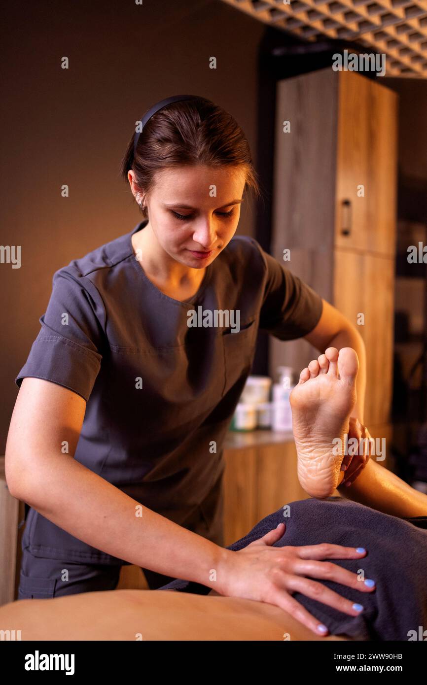 A Young Attractive Masseuse Gives A Back Massage To Her Client At A Spa Or Clinic The
