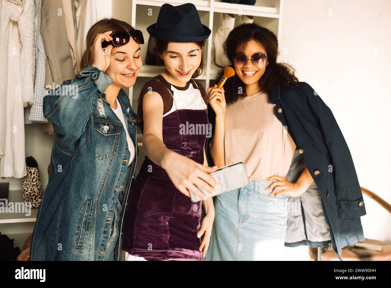 Charismatic teenage girls of different races collect clothes for the ...