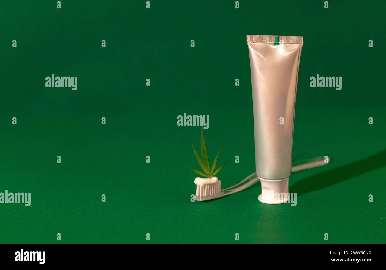 A transparent plastic toothbrush with white Cannabis CBD toothpaste ...
