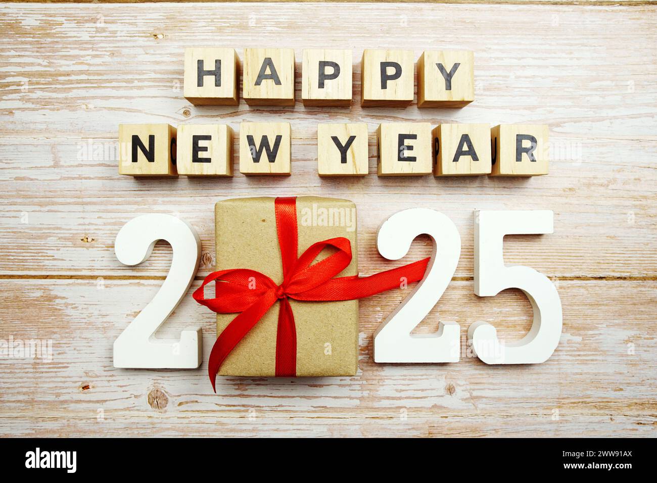 Happy New Year 2025 alphabet letters and gift box presents on wooden ...