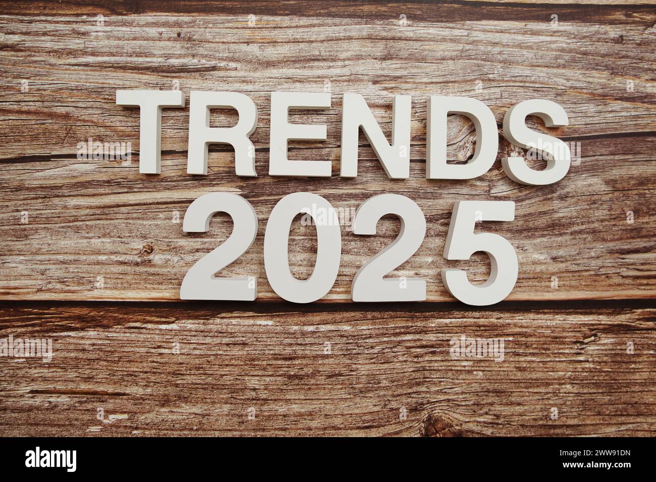 Trends 2025 alphabet letters on wooden background Stock Photo - Alamy