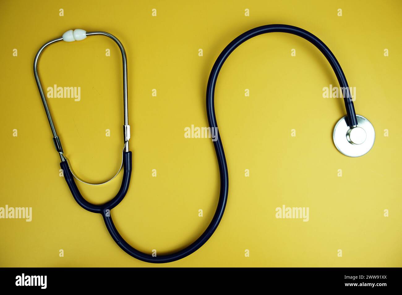 Stethoscope top view on yellow background Stock Photo - Alamy