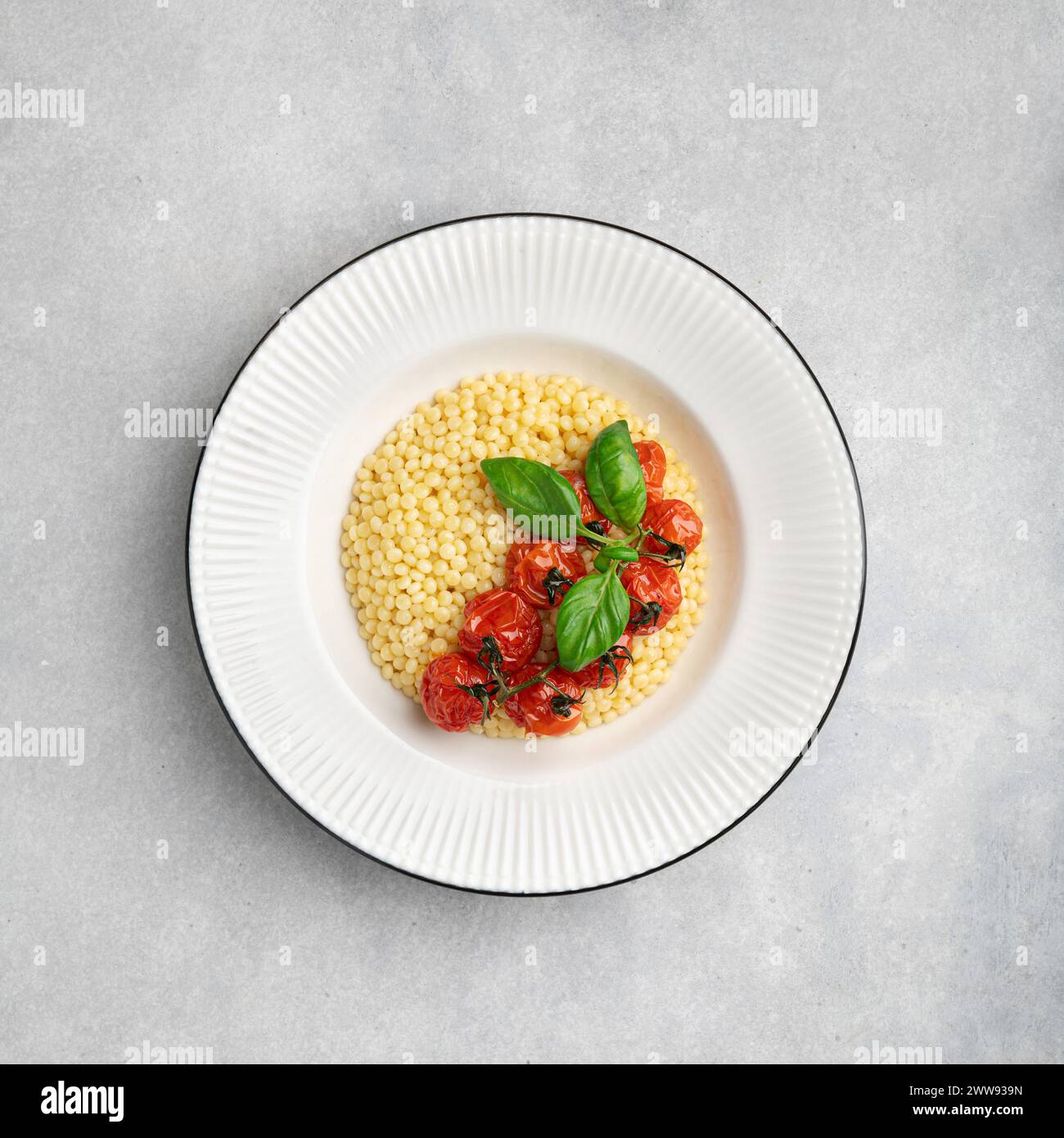 ptitim in a white plate Stock Photo - Alamy