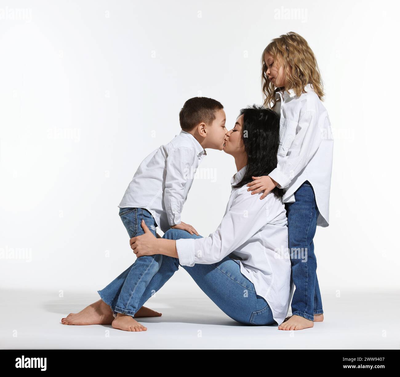 Little children with their mother on white background Stock Photo - Alamy