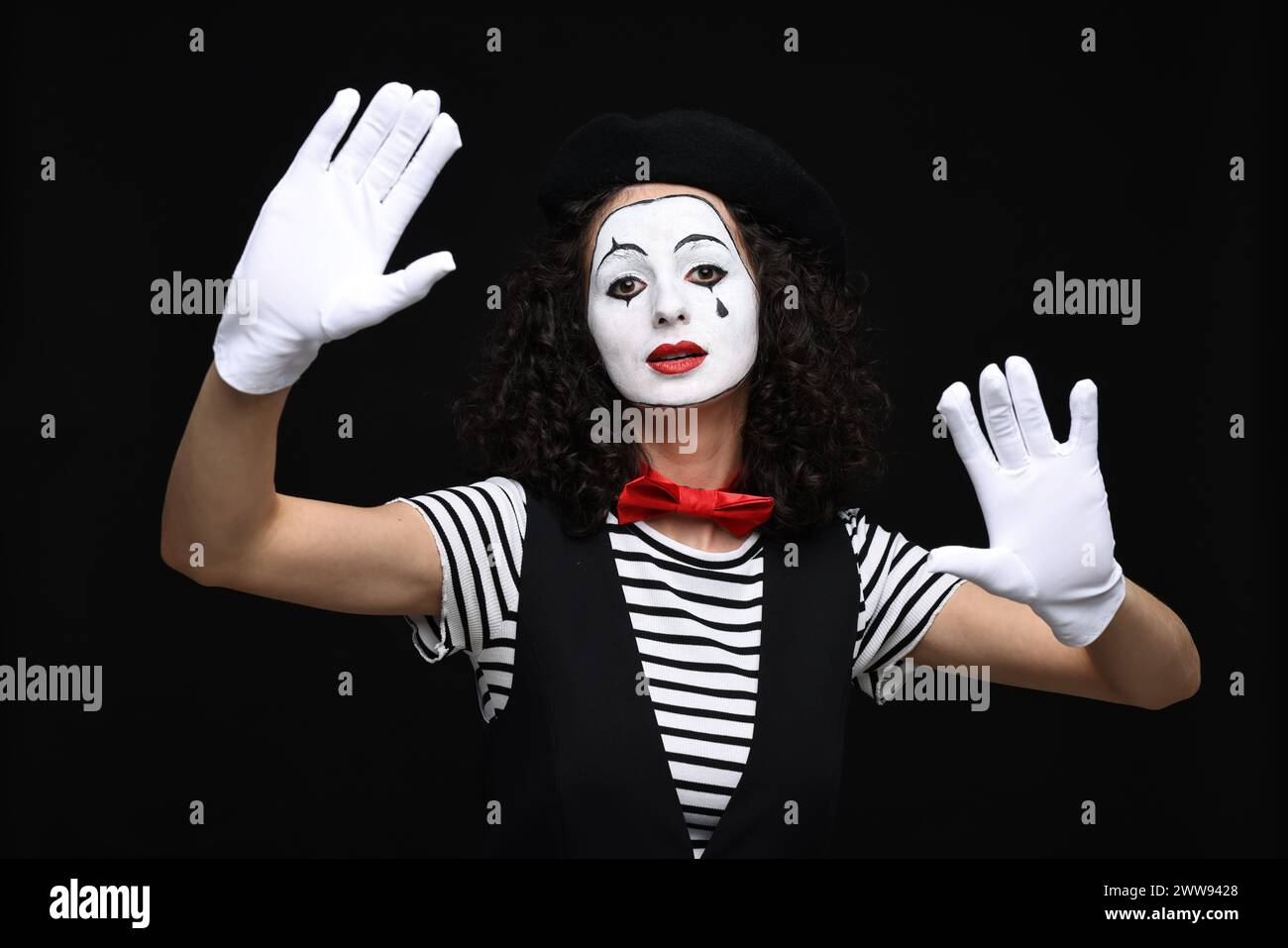 Young woman in mime costume posing on black background Stock Photo - Alamy