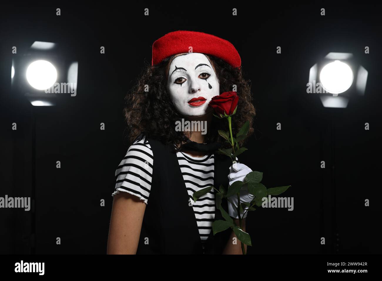 Young woman in mime costume with red rose performing on stage Stock ...