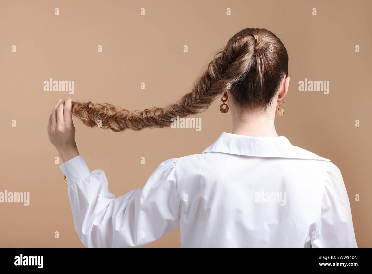Woman with braided hair on brown background, back view Stock Photo - Alamy