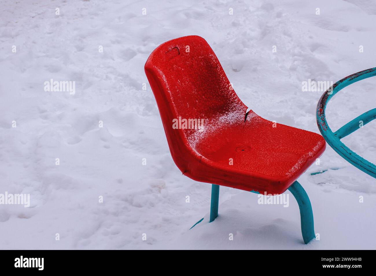 Seat from a carousel on a snow background Stock Photo - Alamy