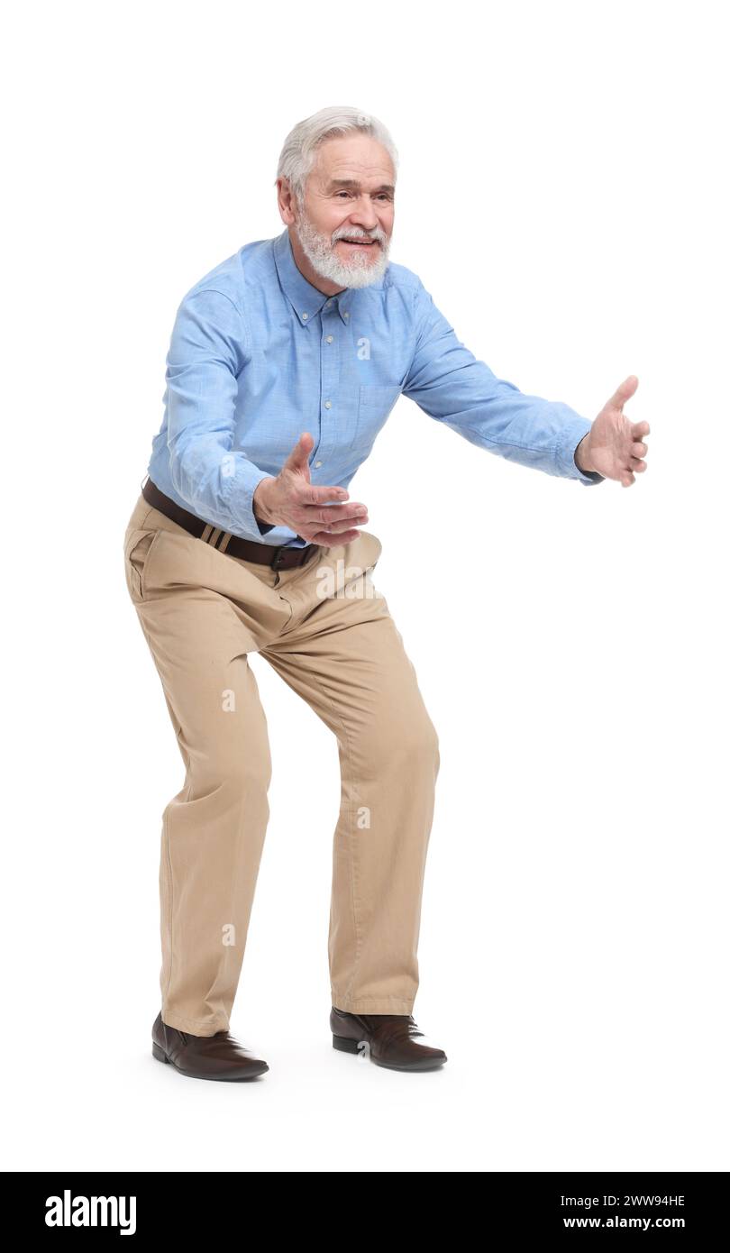 Senior man greeting someone on white background Stock Photo - Alamy