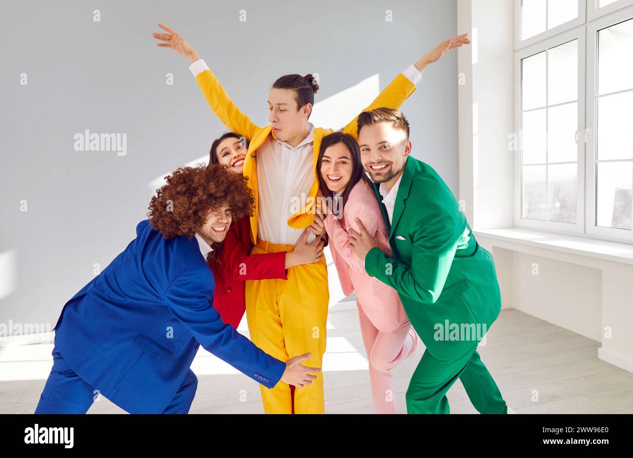 Group of happy, joyful, young, smiling friends in colorful party suits ...