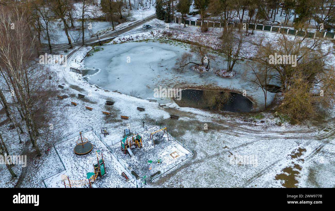 Drone photography of iced up pond in public park and ducks in it during ...