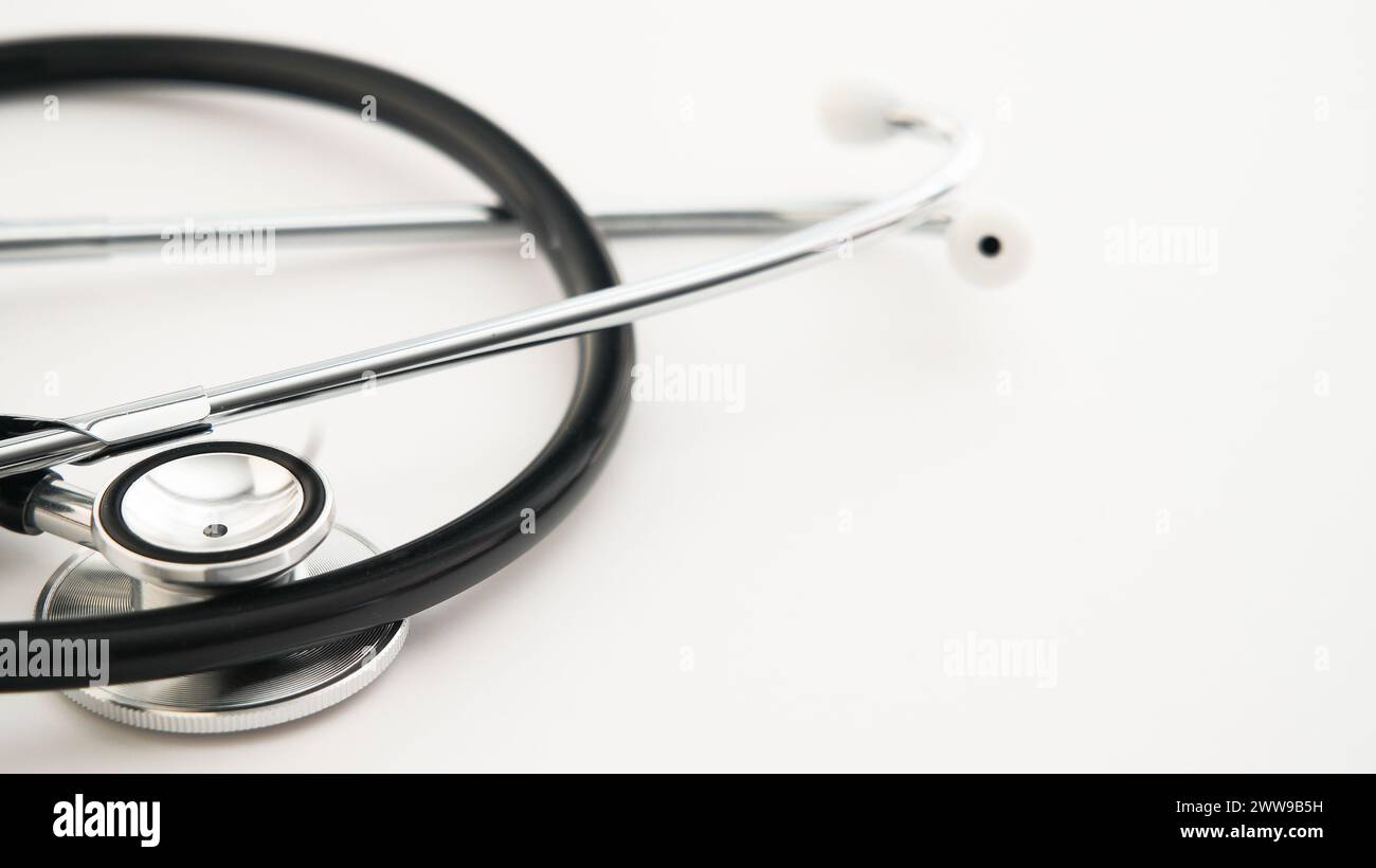 A stethoscope, indicative of the medical profession, is laid out on a ...