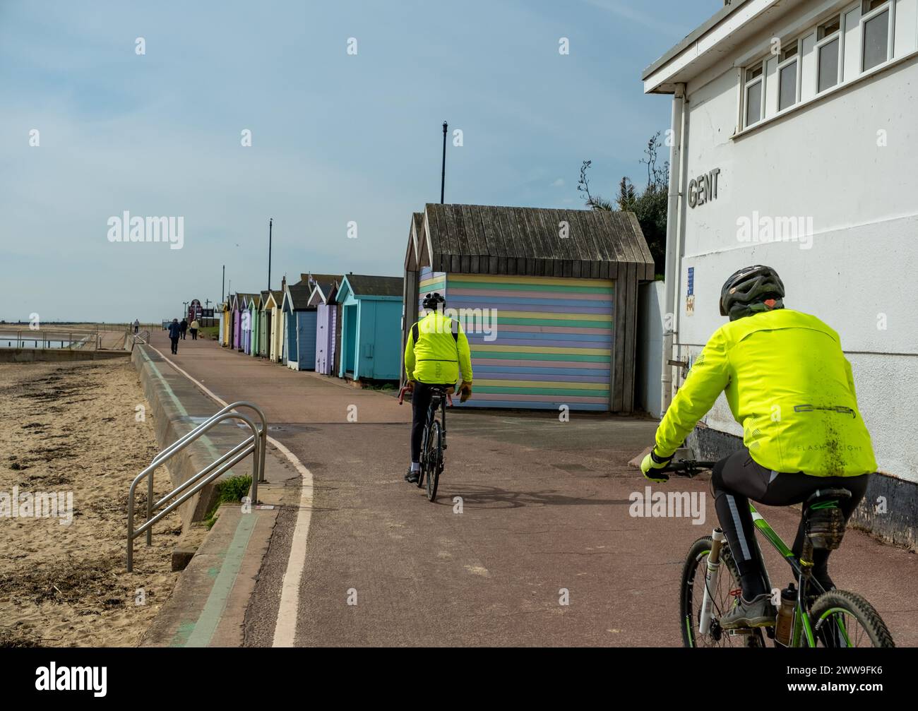 Clacton-on-Sea, Essex, UK – March 2024. Two cyclists in hi viz biking ...
