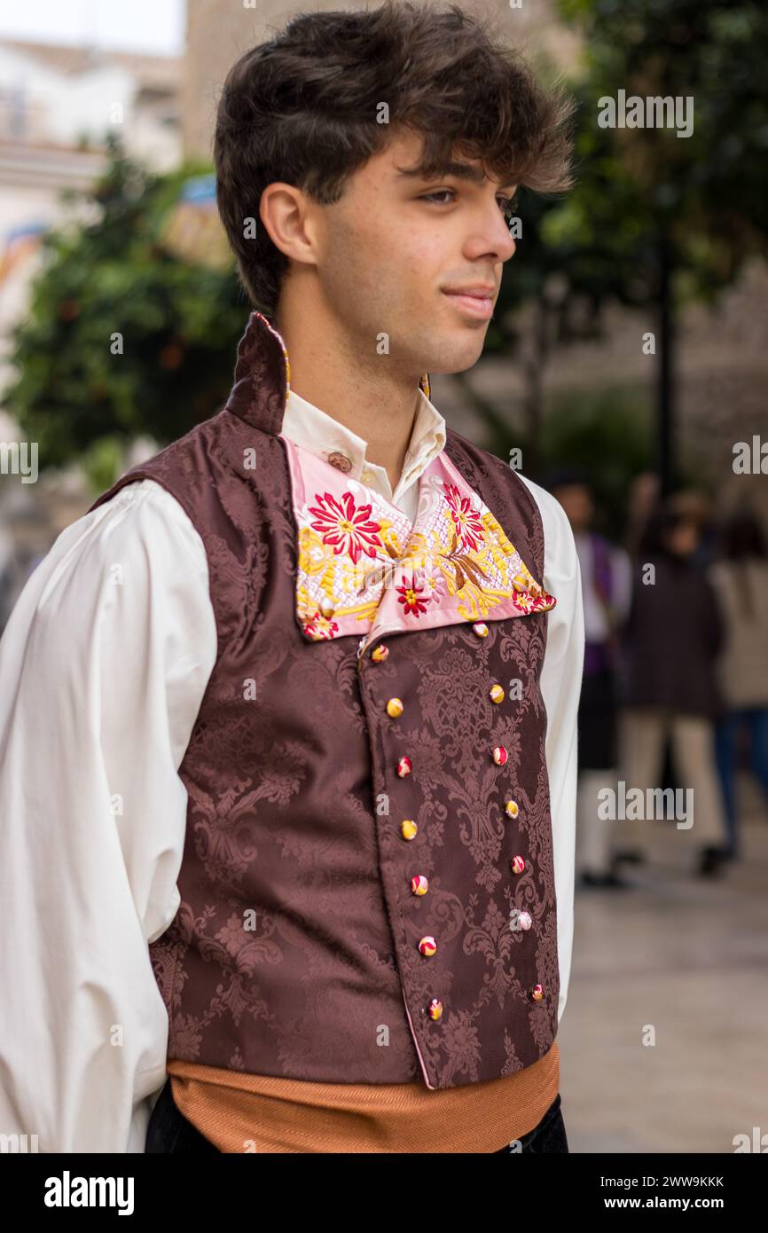 Valencian Vibrance in Gandia’s Fallas, a man’s traditional attire tells ...