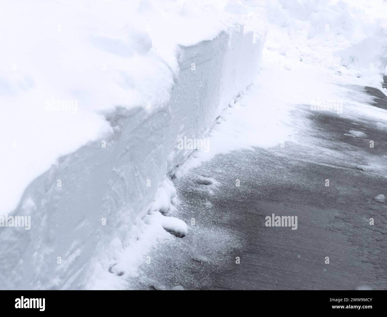 Winter Precision: Snow-Cleared Pathway Beside a White Wall Stock Photo ...