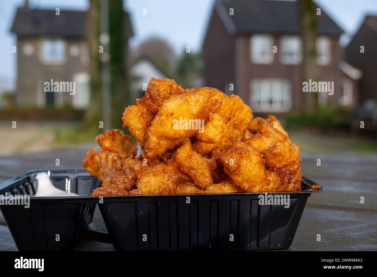 Seafood, outdoor eating of diep-fried cod fish pieces served with ...