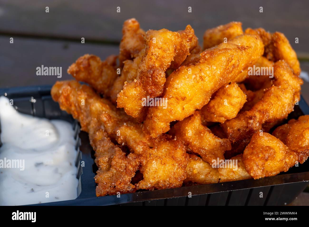 Seafood, outdoor eating of diep-fried cod fish pieces served with ...