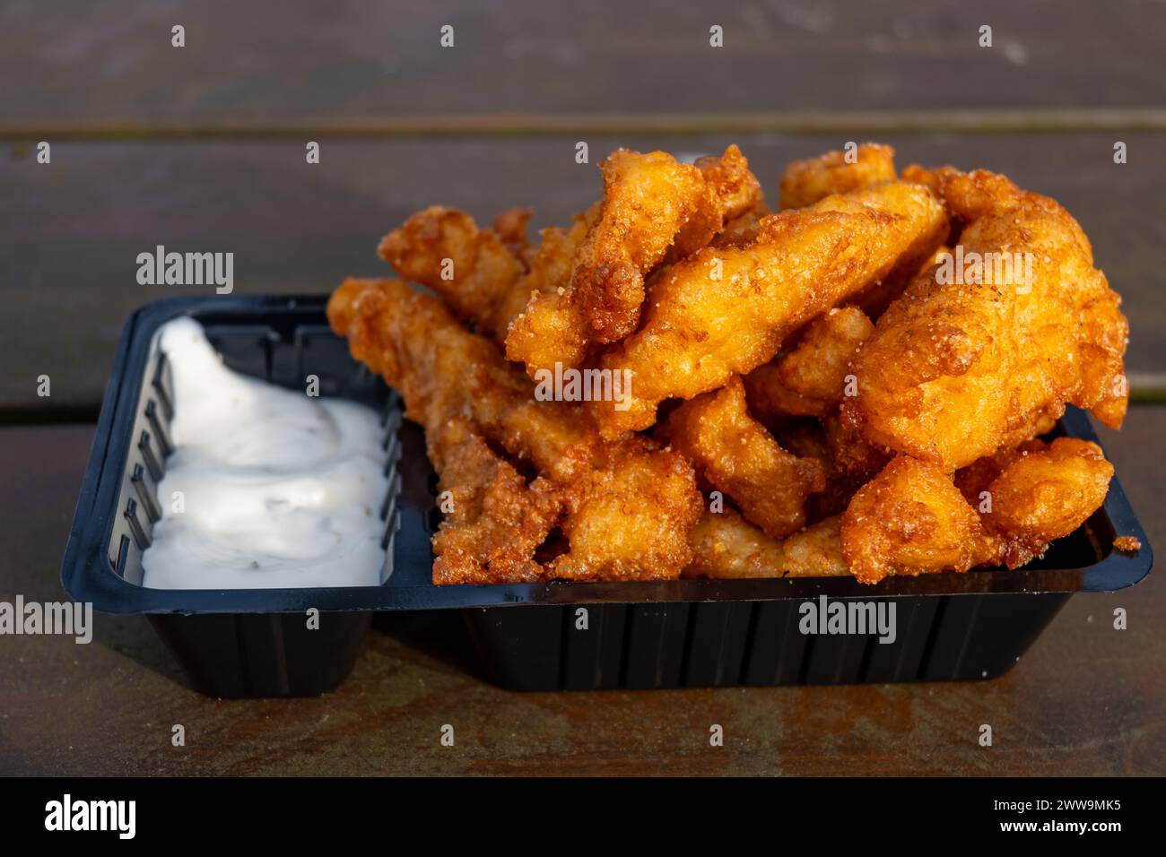 Seafood, outdoor eating of diep-fried cod fish pieces served with ...