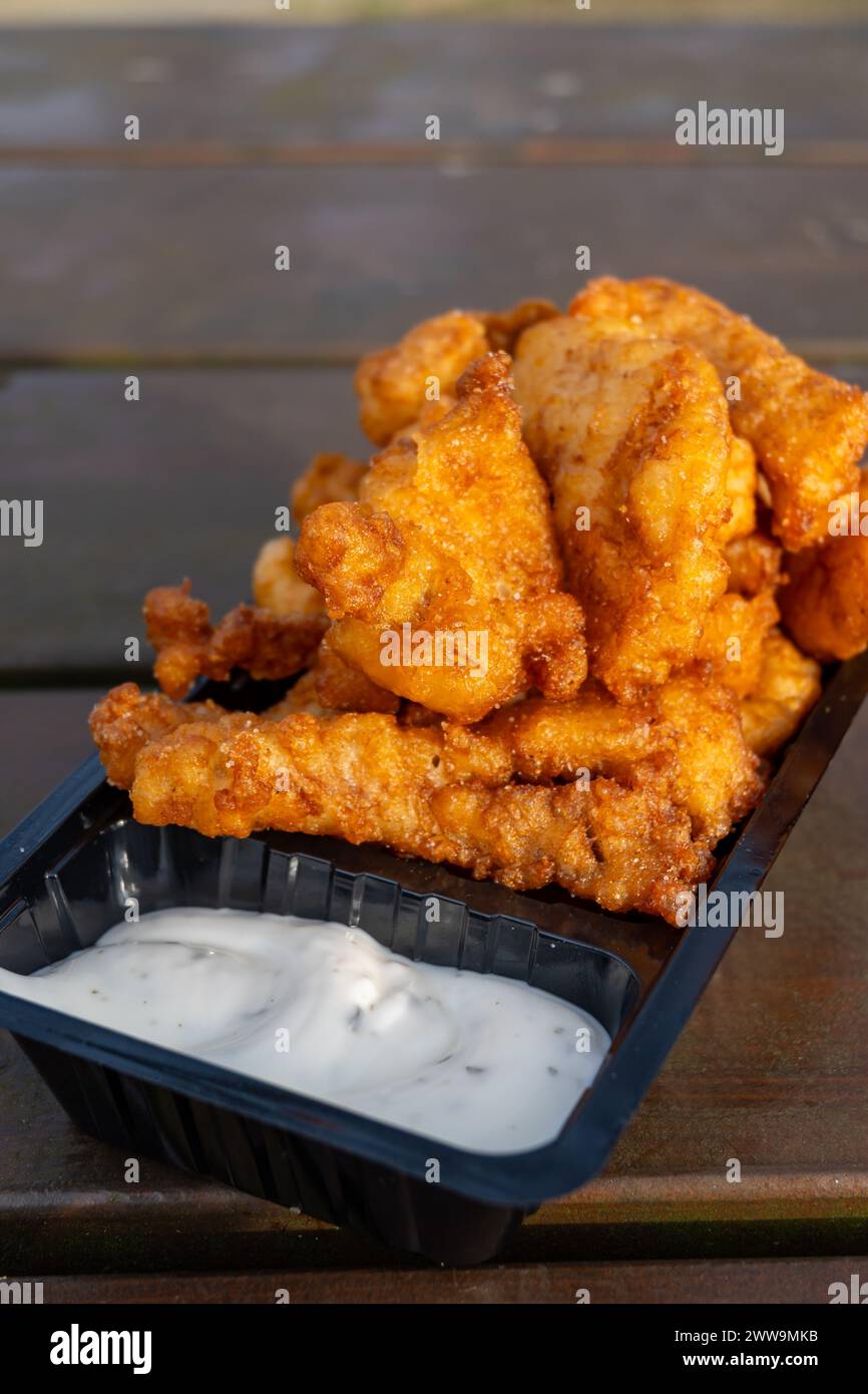 Seafood, outdoor eating of diep-fried cod fish pieces served with ...