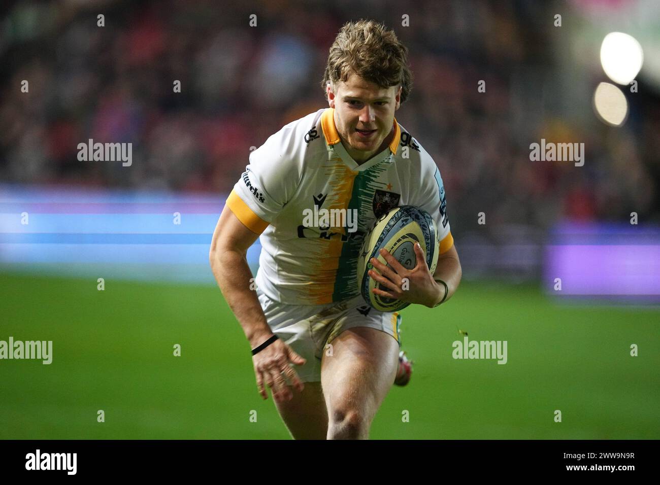 Jake Garside of Northampton Saints slides in to score a try during the ...