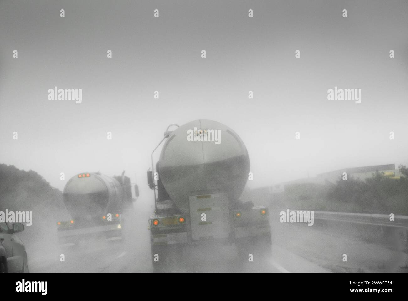 tanker trucks drive on highway in rain storm - Wisconsin - USA Stock ...