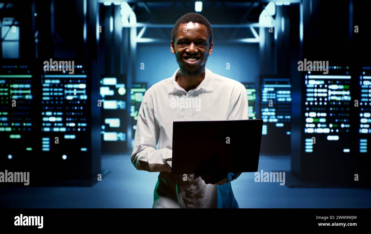 Computer scientist walking between data storage devices in computing server room, ensuring ...