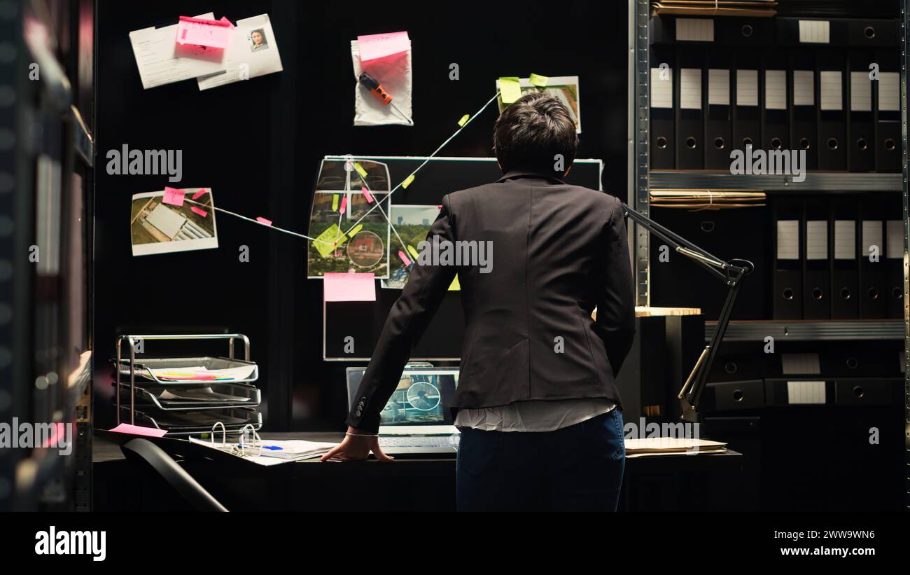 Police investigator looking at clues board in incident room, analyzing ...